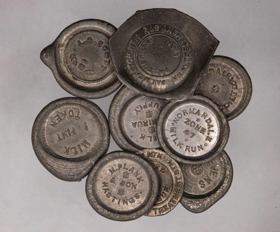 9 x NZ assorted milk/dairy tokens. Most are trial strikes in lead ...
